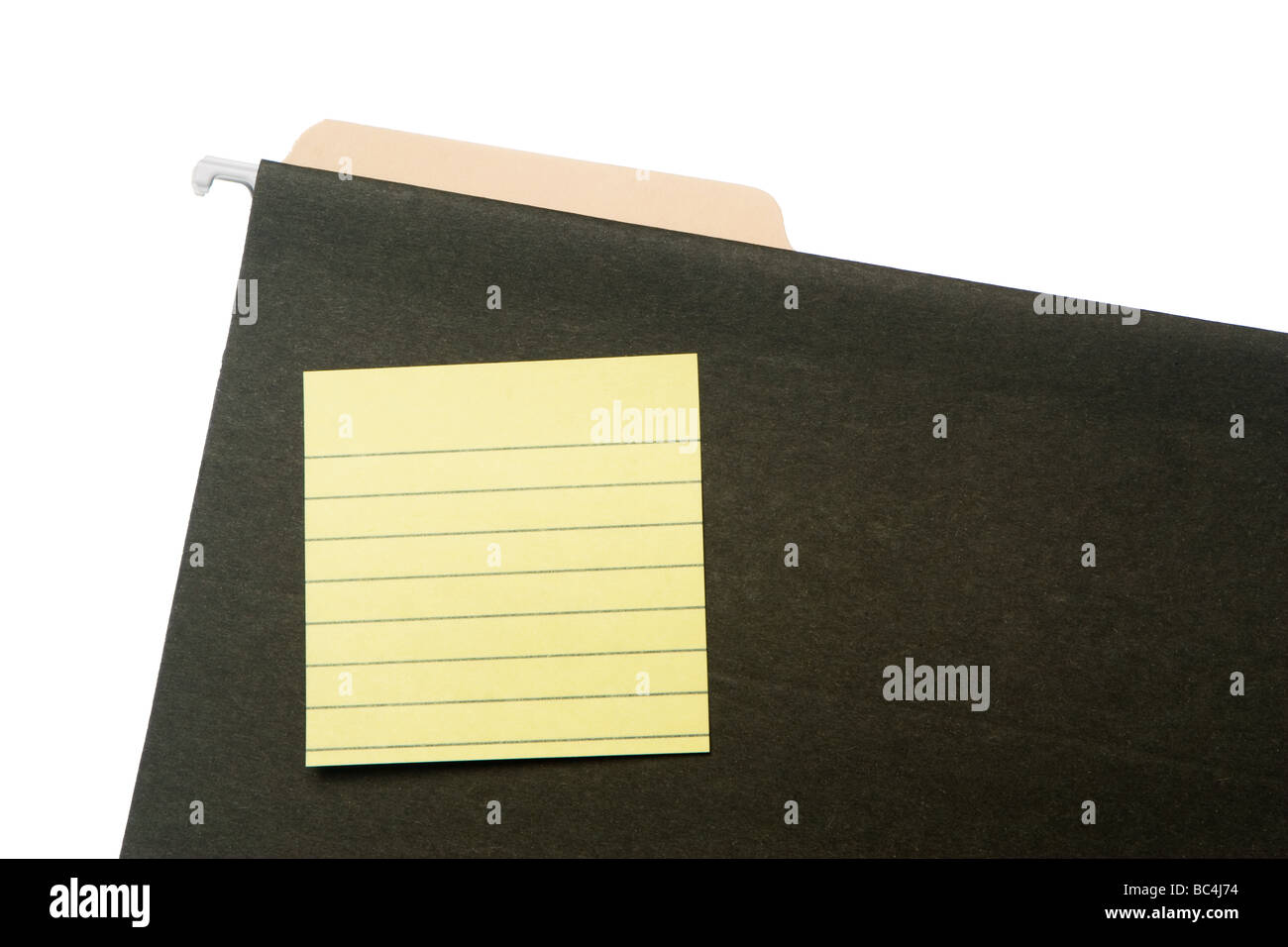 Blank lined post it note on green hanging file folder. Tab of manila ...