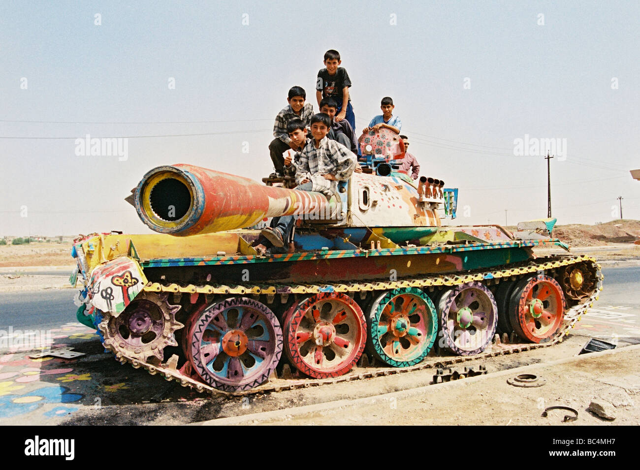 Kurdish children from Kirkuk sit atop a damaged Iraqi T-62 battle tank ...