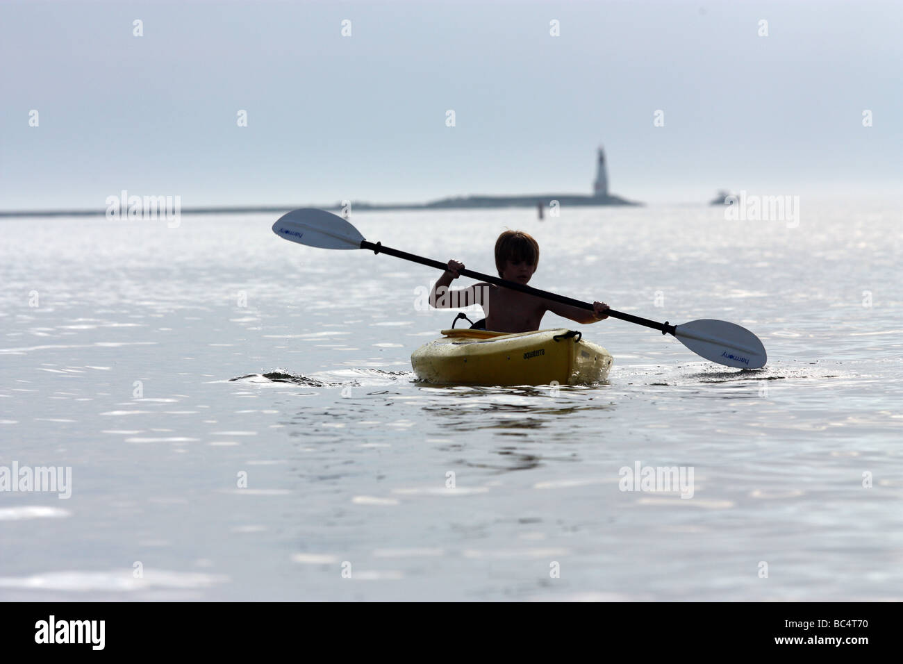 Young boy paddling kayak Stock Photo - Alamy