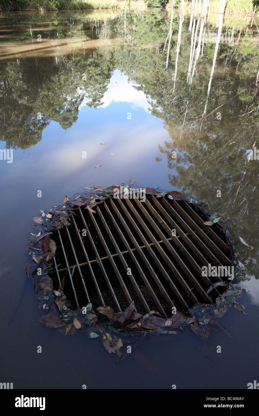 DRAINAGE GRATE IN LAKE WITH SKY REFLECTION Stock Photo - Alamy