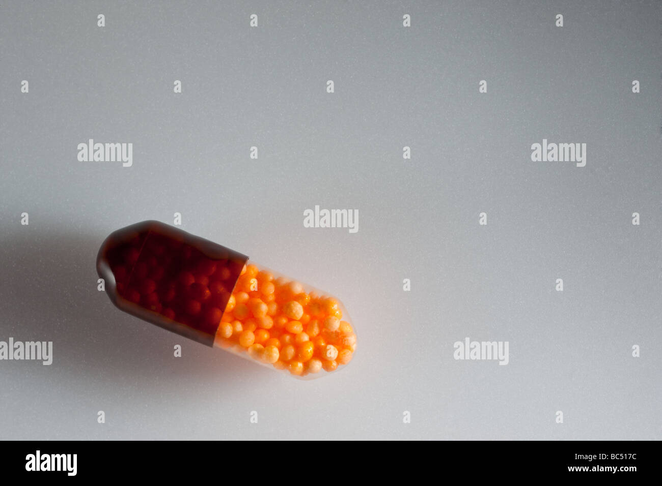 Closeup of time-release capsule on white textured background Stock ...