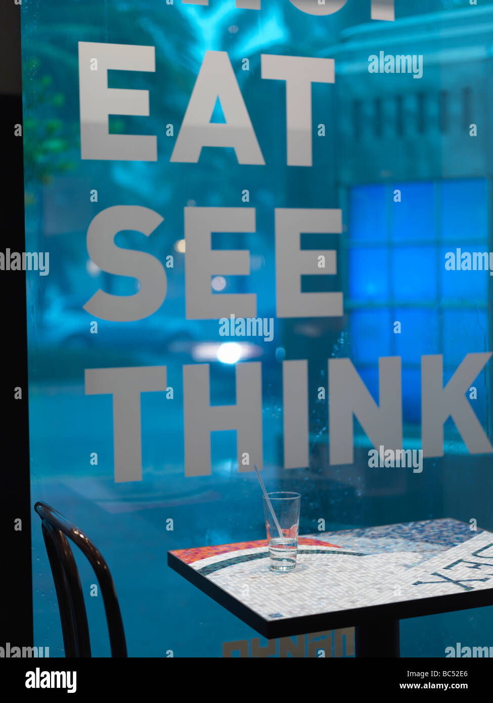 cafe table beside a window with the words eat, see, think Stock Photo ...