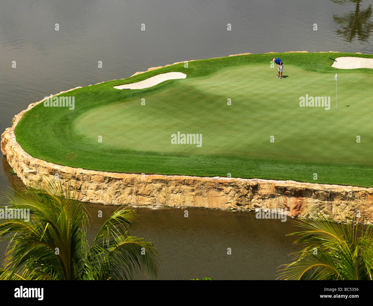 18th hole on golf course with golfer Stock Photo - Alamy