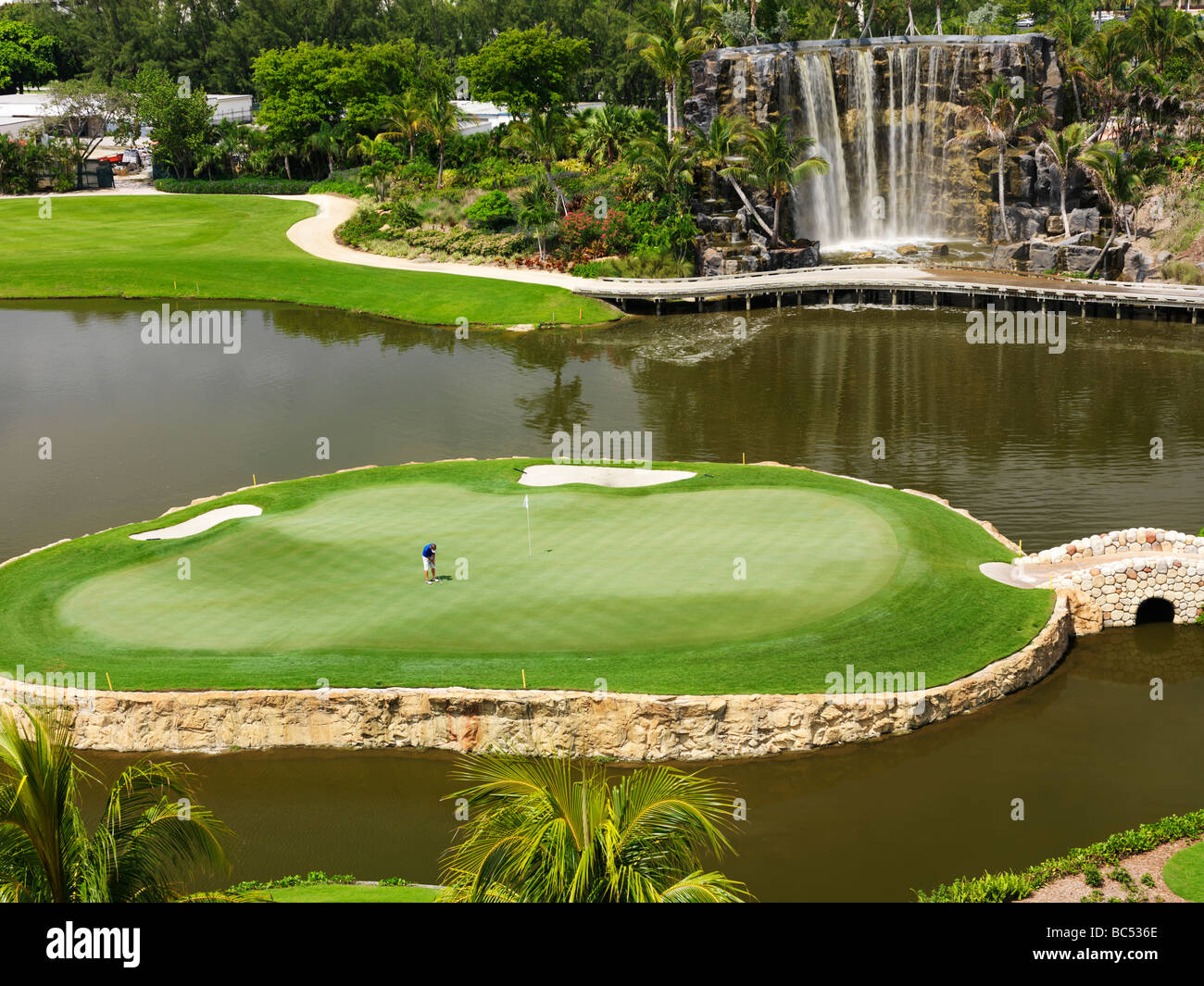 18th hole on golf course with golfer Stock Photo - Alamy