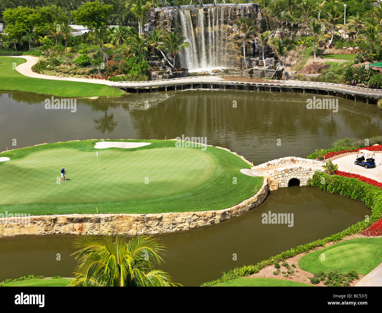 18th hole on golf course with golfer Stock Photo - Alamy