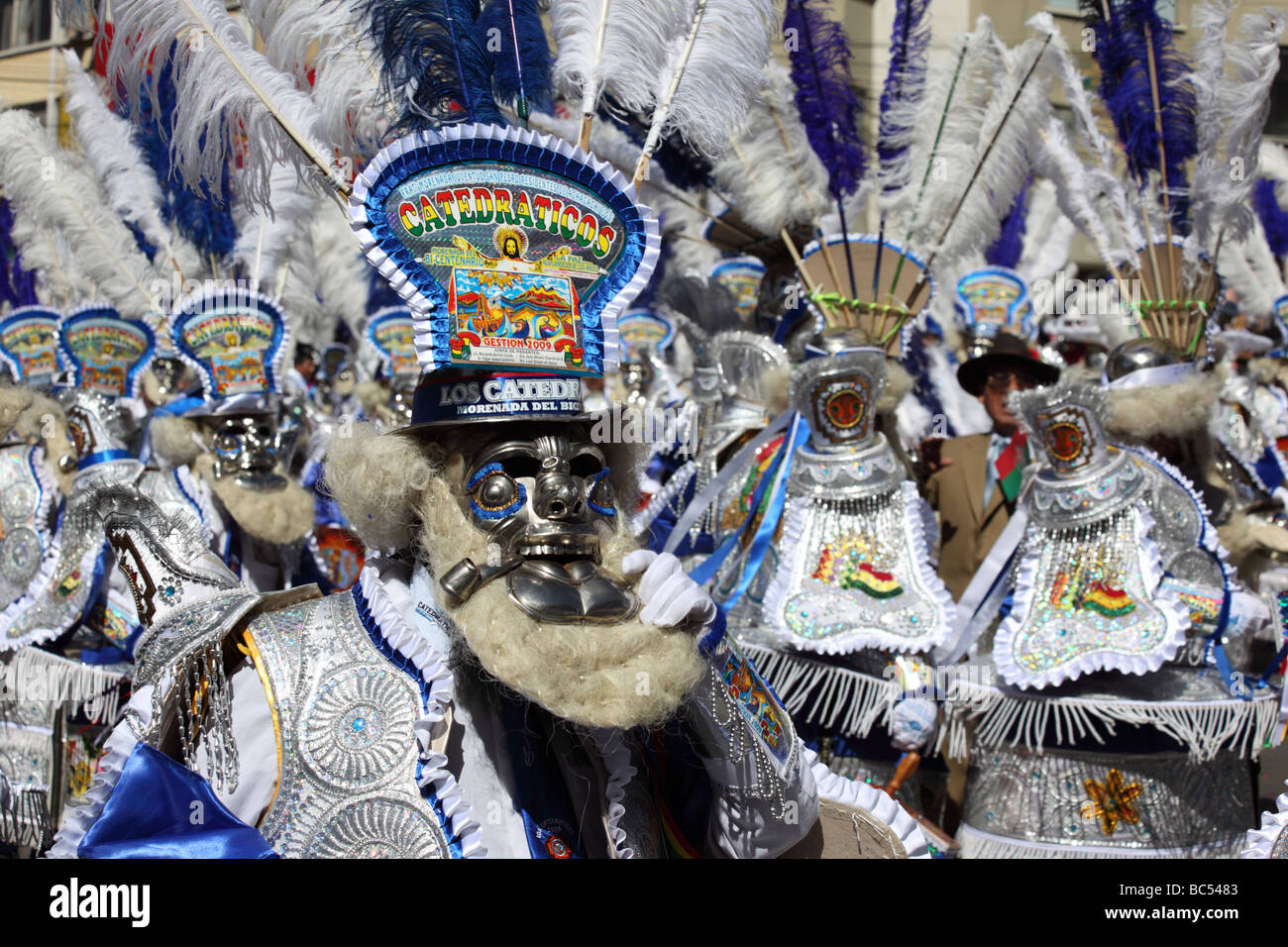 Rey moreno morenada dancers wearing silver face masks and white feather ...