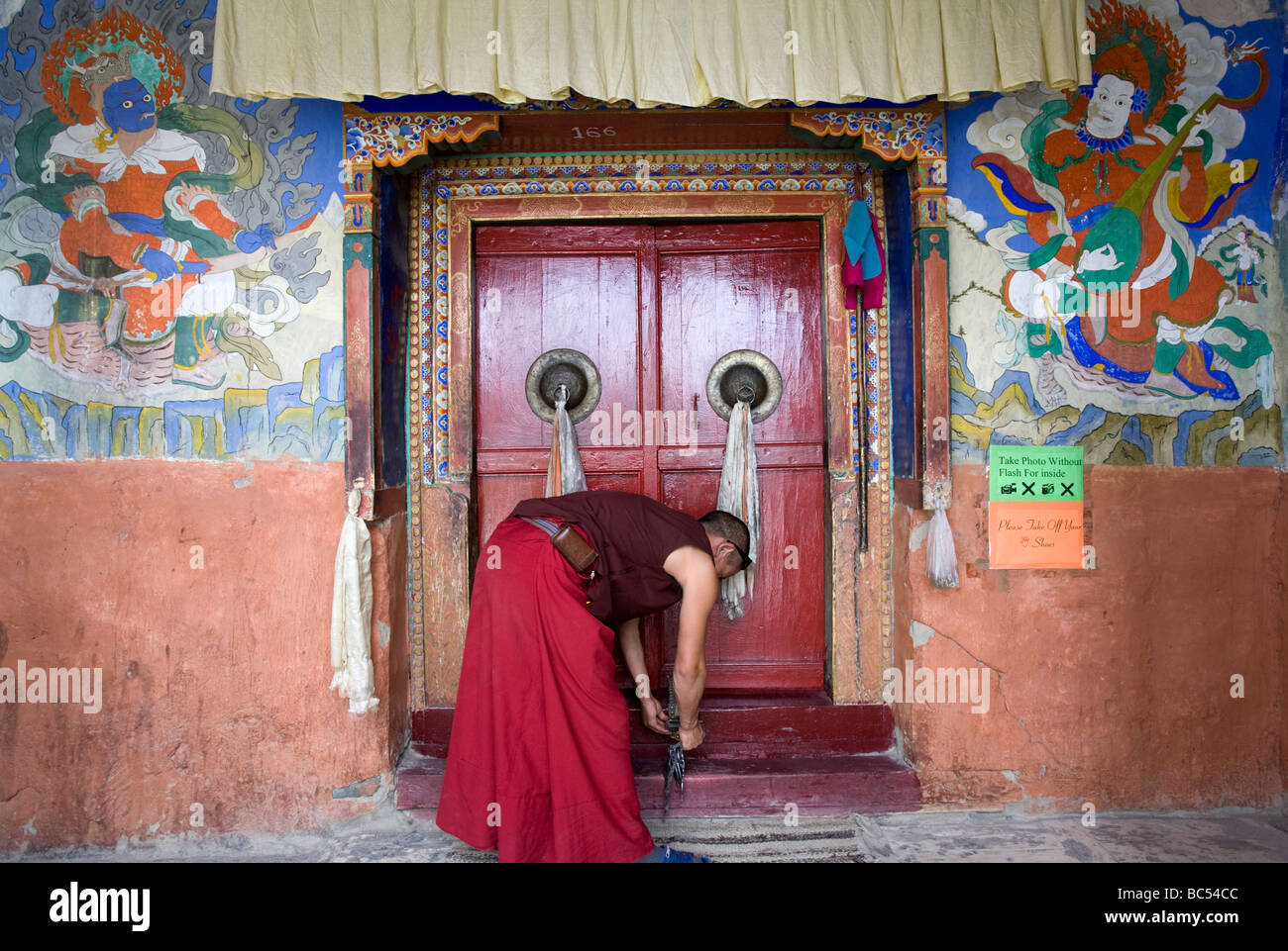 Buddhist monk opening temple door hi-res stock photography and images ...