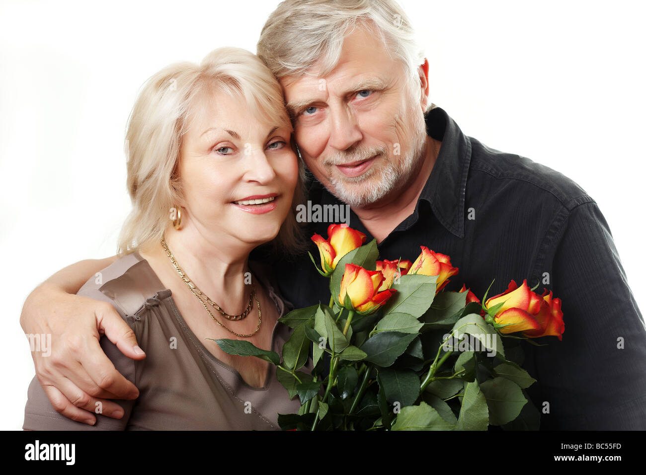 Portrait of an elderly couple with a bunch of roses Stock Photo - Alamy