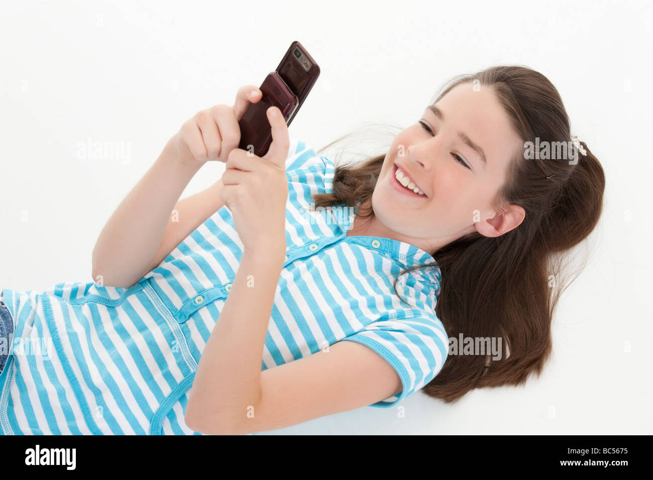Cute Caucasian girls texting on a cell phone Stock Photo - Alamy