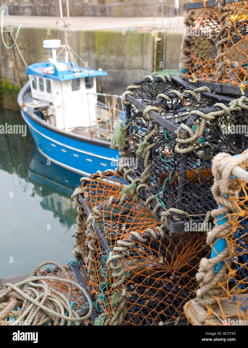 A boat and fishing crates in the harbour of St Abbs, a pretty fishing ...