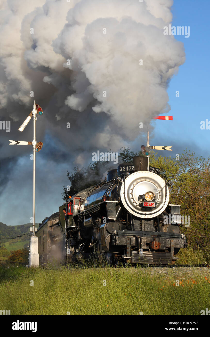 Southern Pacific steam locomotive No. 2472 passes by the signal arms ...