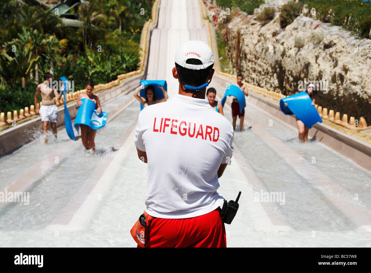 Lifeguard at end of "Naga Racer" slide in Siam Park, The Water Kingdom ...