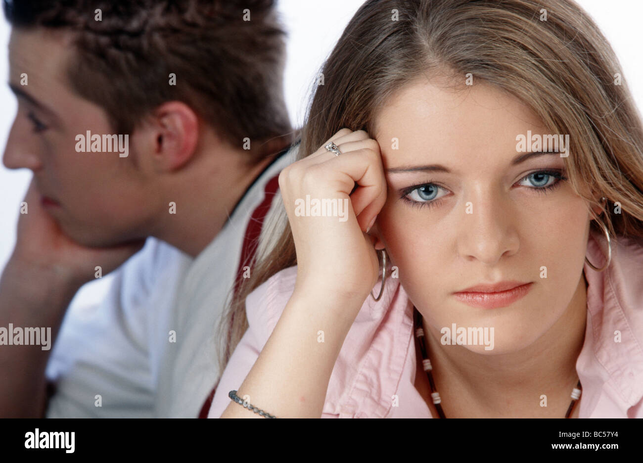 Couple back to back portrait of a sad looking couple Stock Photo - Alamy