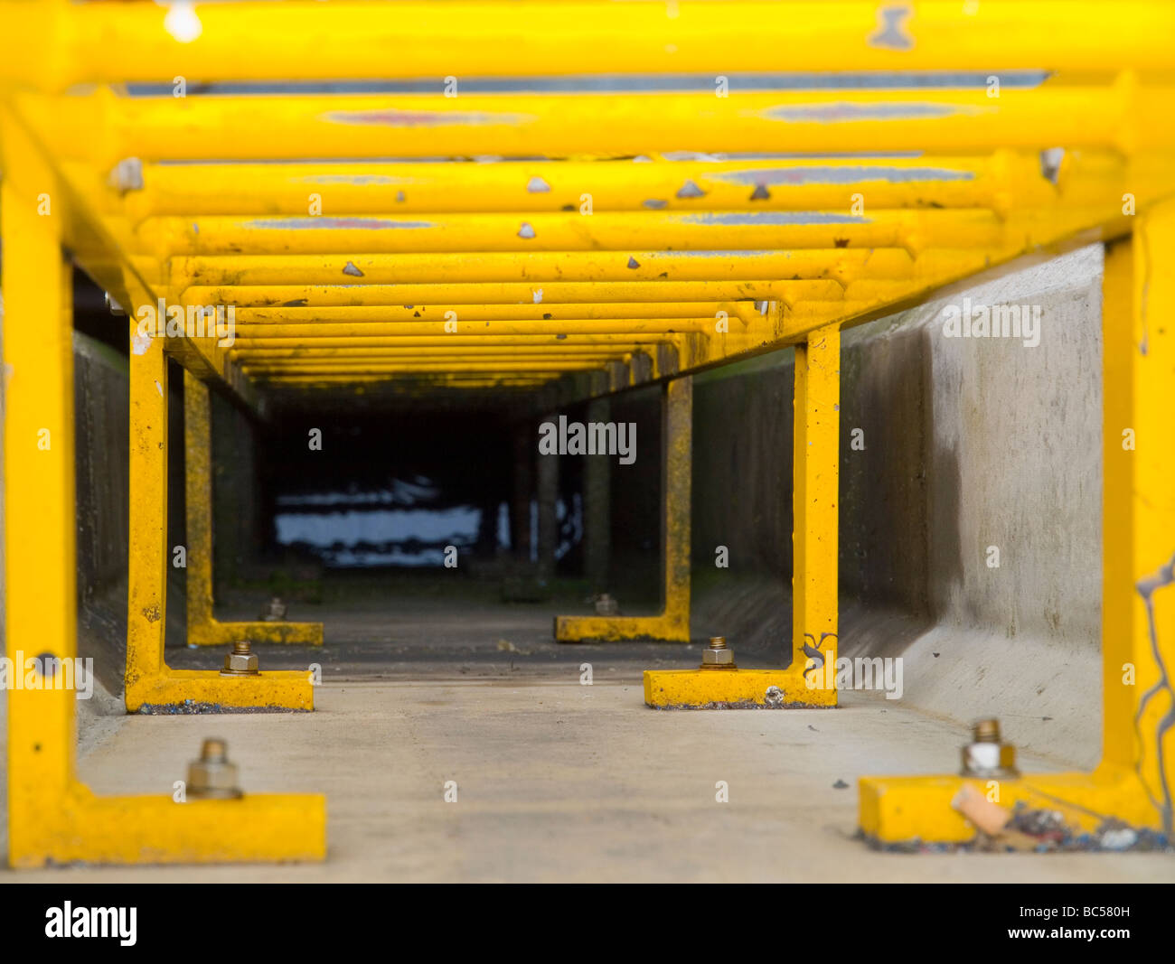 Looking down into a yellow metal ladder attached to the side of the ...