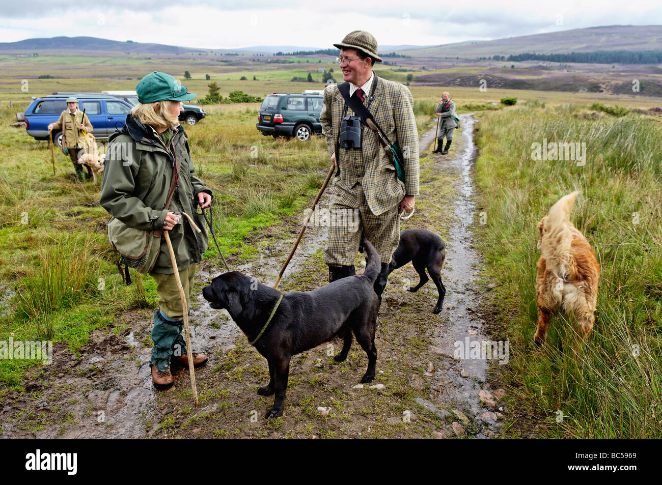 Dog Handler and Gamekeeper Talking on Moor after a Driven Red Grouse ...