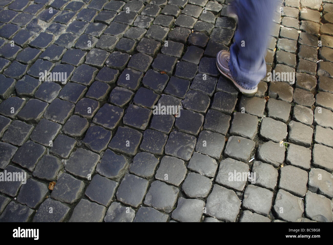 one person walking on city street pavement at night Stock Photo - Alamy