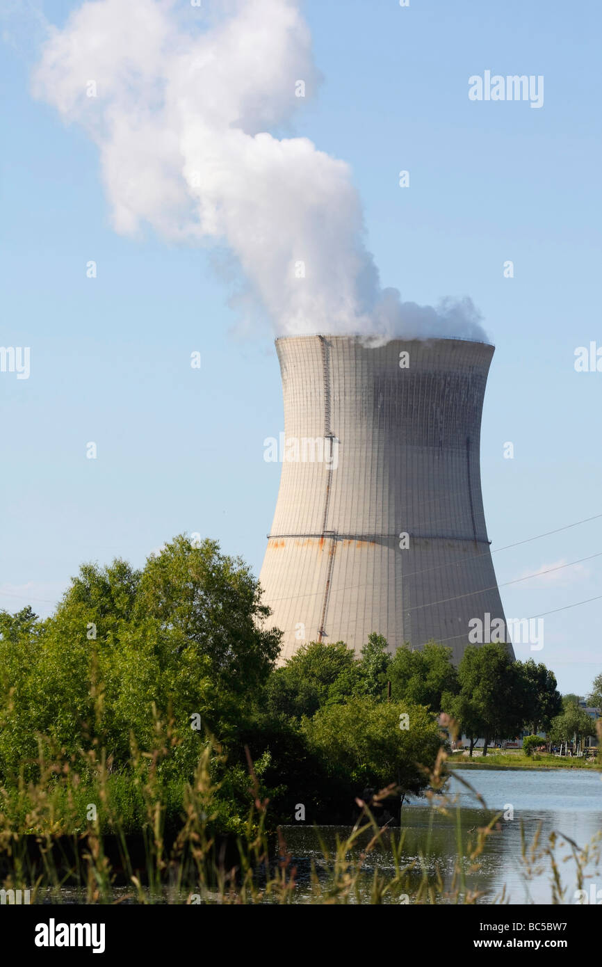 Chimney of a nuclear power plant in the green nature against blue sky ...