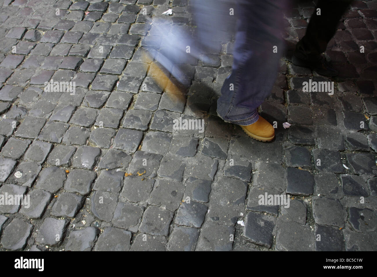 one person walking on city street pavement at night Stock Photo - Alamy