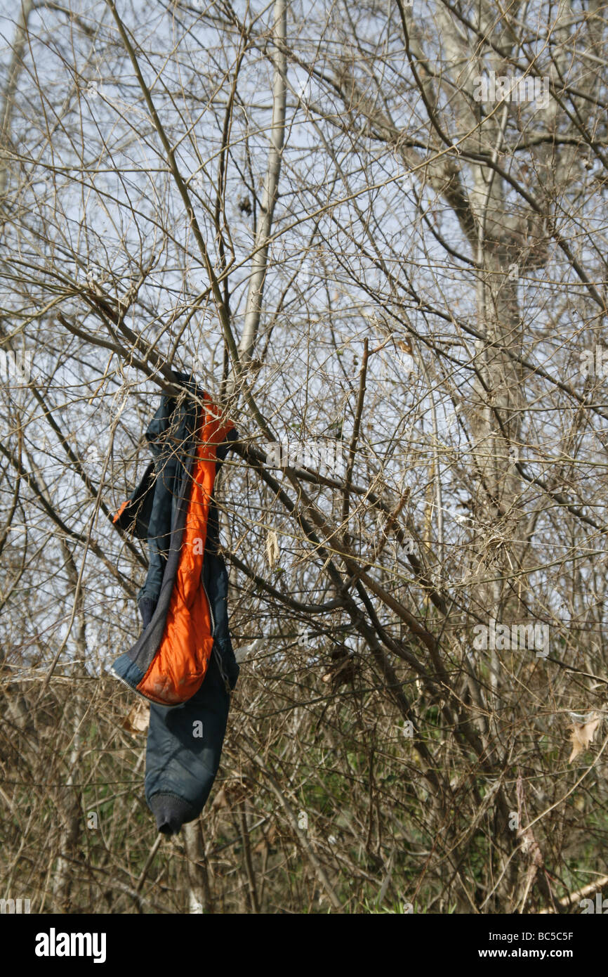 one jacket stuck in tree branches in countryside after river flood ...