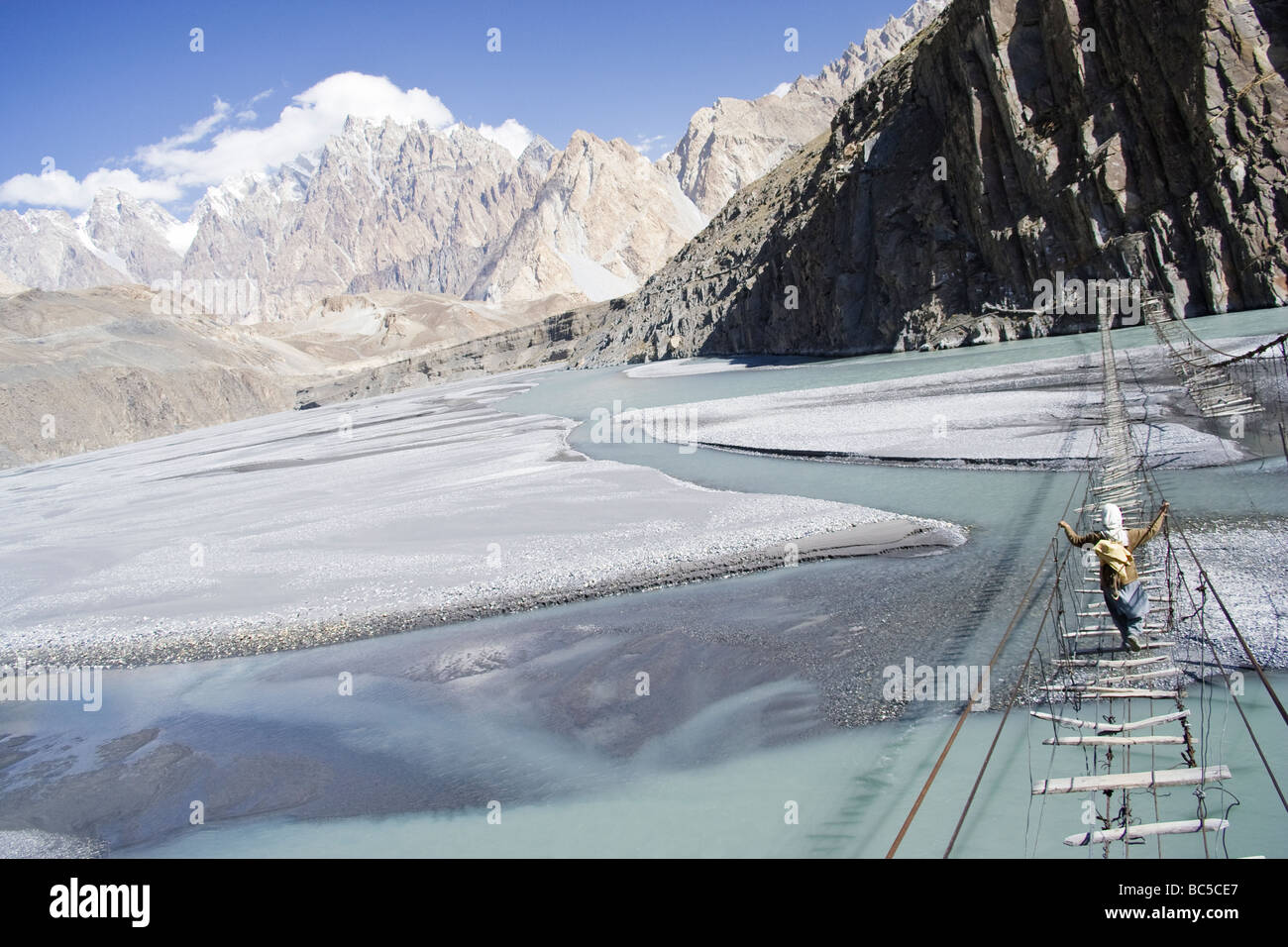 Local crossing a delicate rope bridge over the Hunza river, Karakorum ...