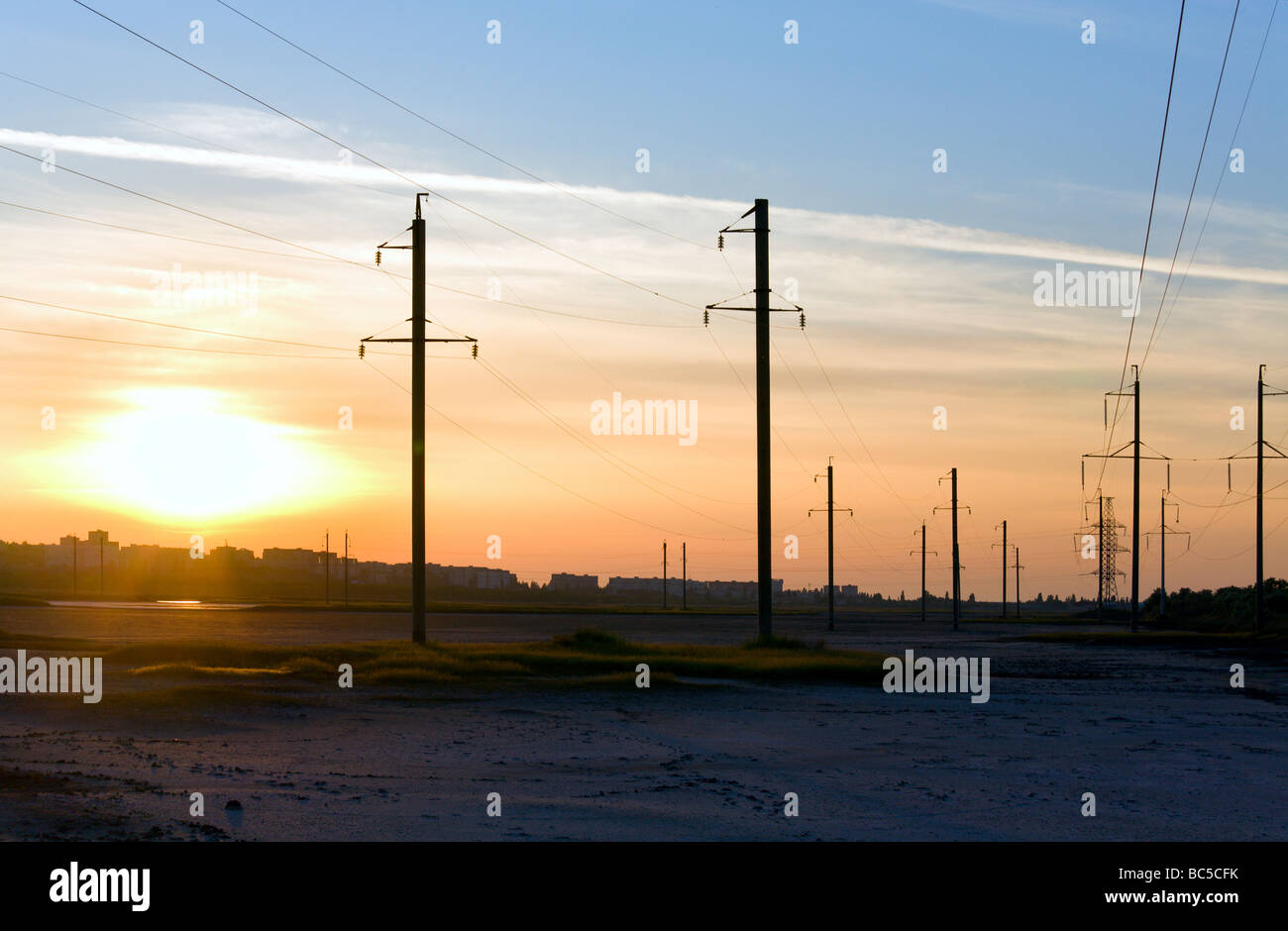 Sunset sky above the town and high-tension transmission line Stock ...