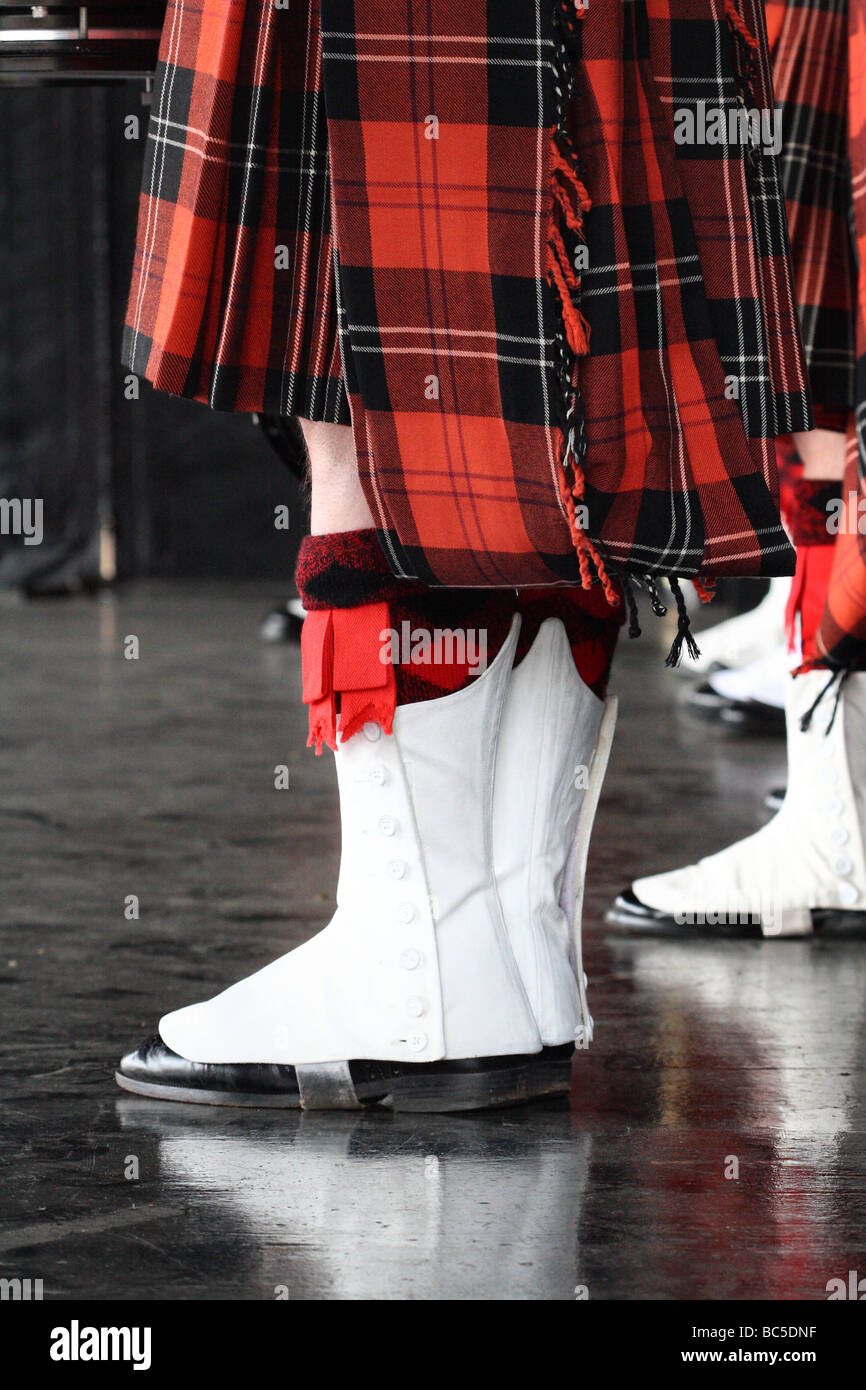 Piper clad in Ramsay tartan Stock Photo - Alamy