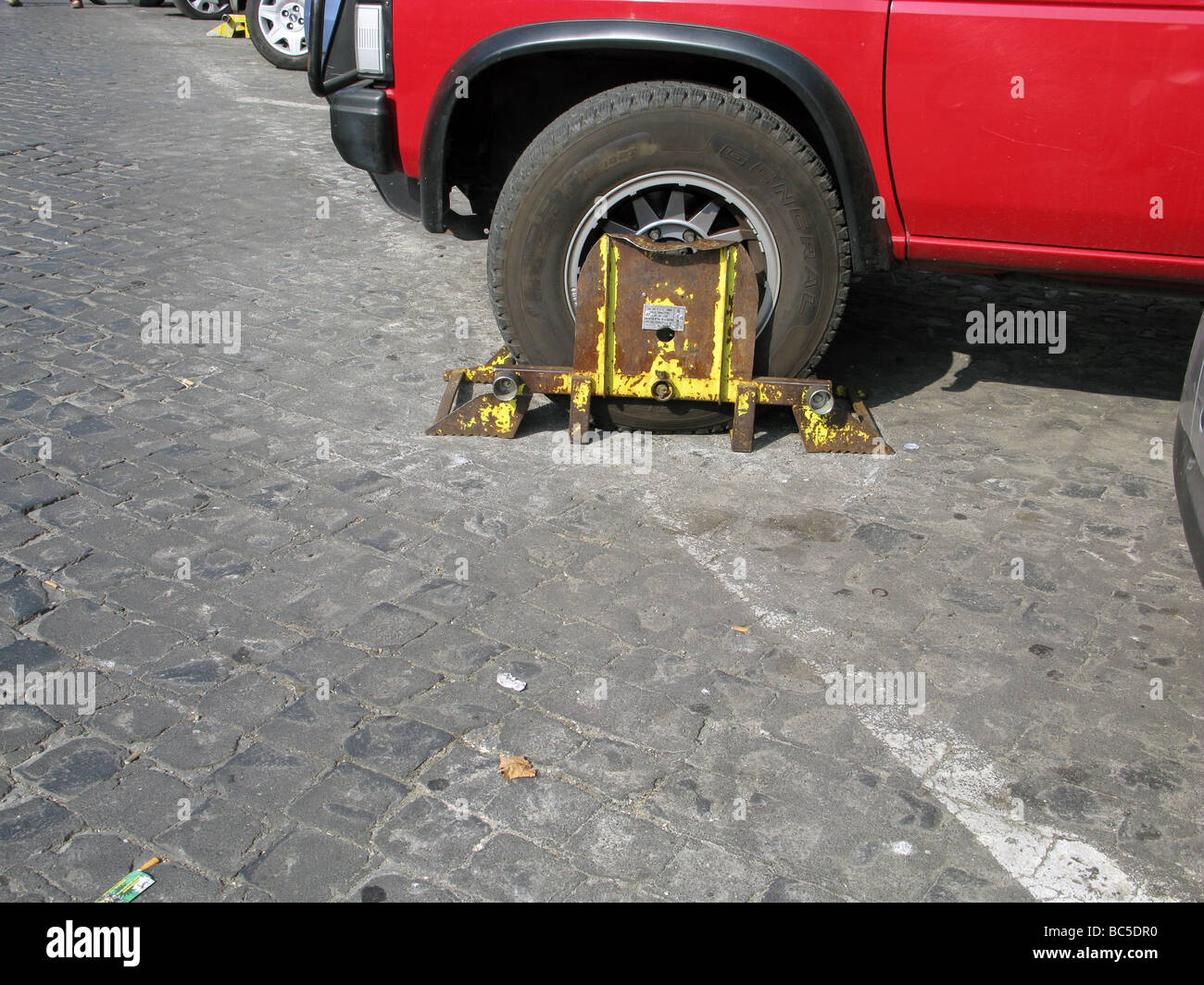 red car clamped in street road in city town Stock Photo - Alamy