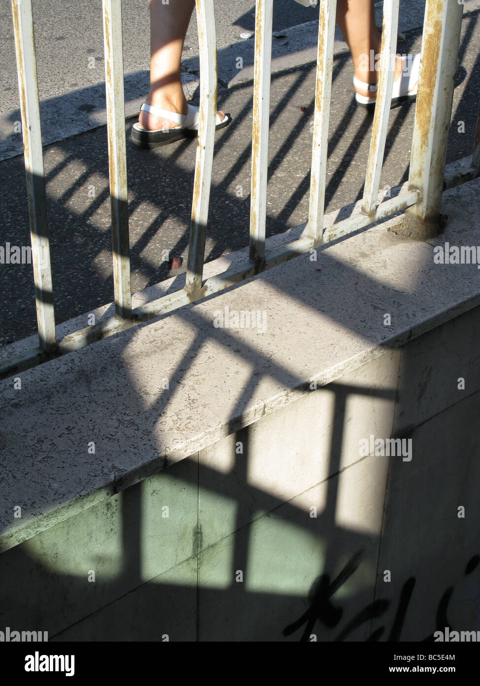 shadow of metal fence on wall in street in city town Stock Photo - Alamy