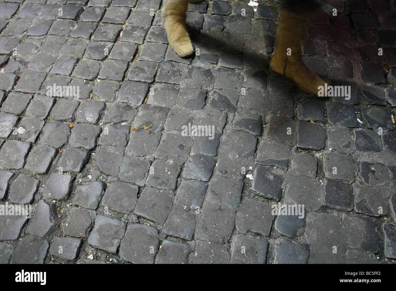 person walking on city street pavement at night Stock Photo - Alamy