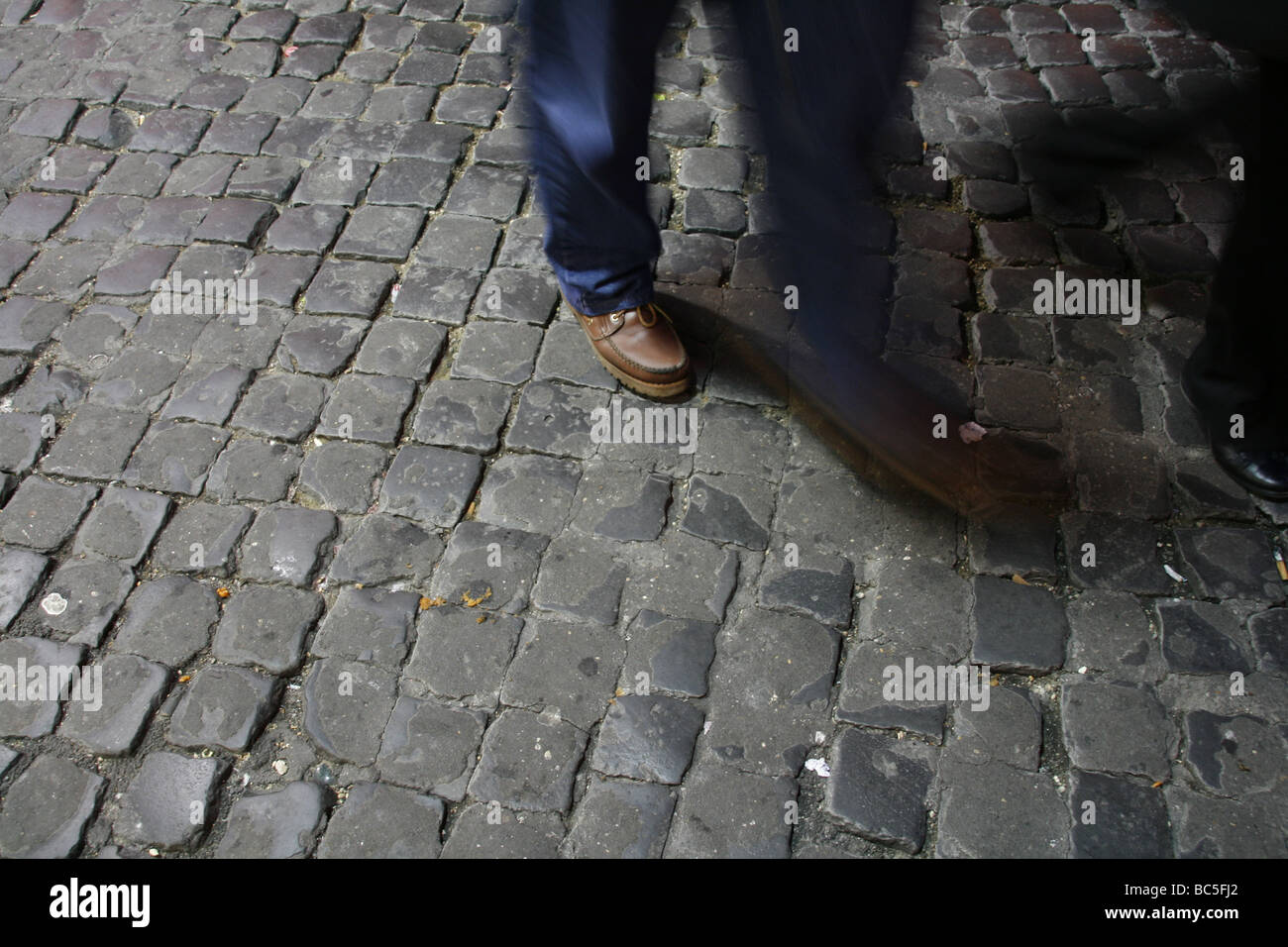 one person walking on city street pavement at night Stock Photo - Alamy