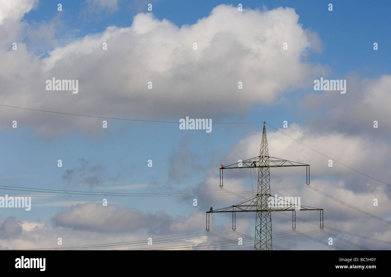 Men working on electricity pylon Stock Photo - Alamy