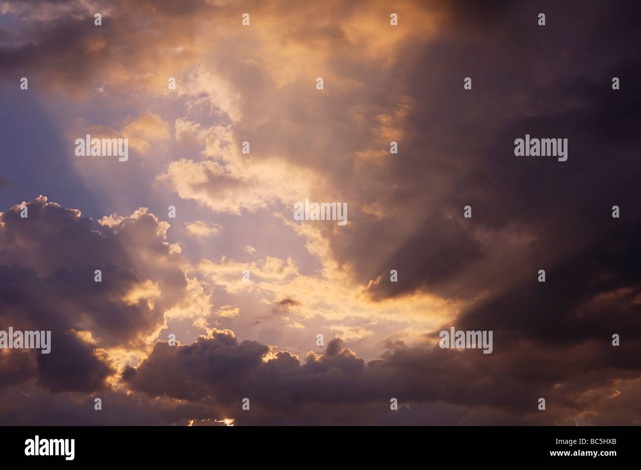 Sun rays shining through clouds, low angle view Stock Photo - Alamy