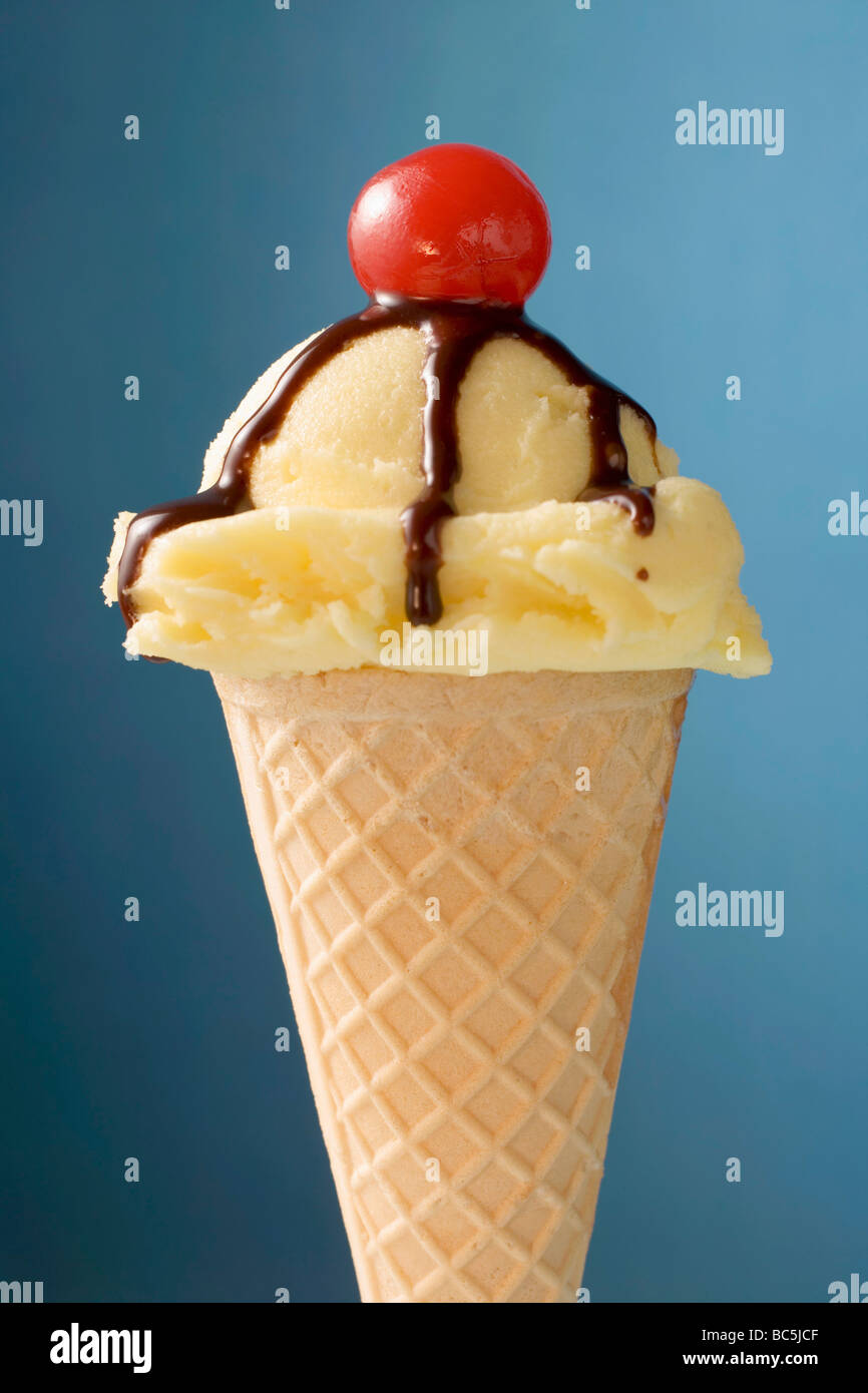 Vanilla ice cream cone with chocolate sauce & cocktail cherry Stock ...