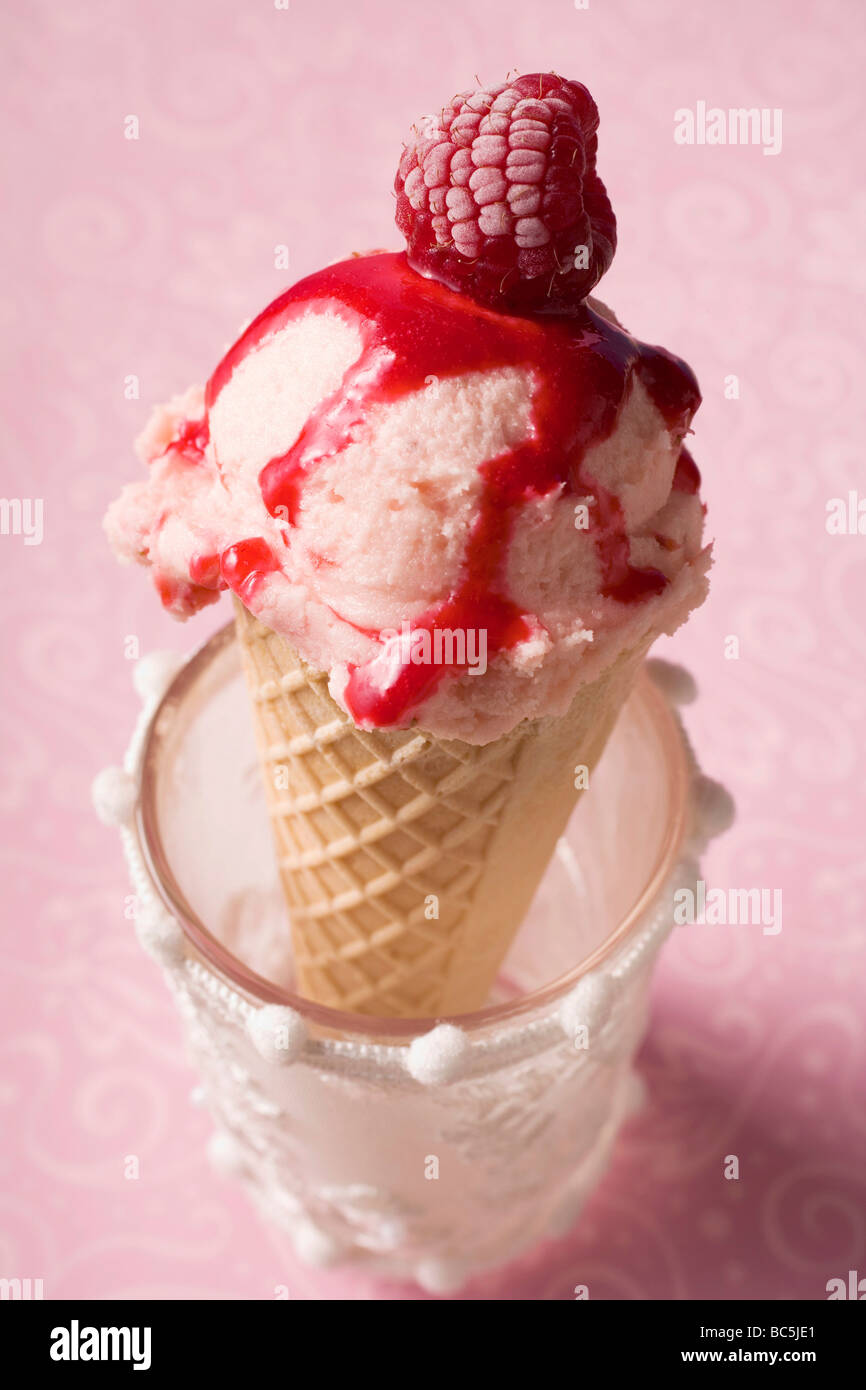Ice cream with raspberry and raspberry sauce in wafer cone Stock Photo ...