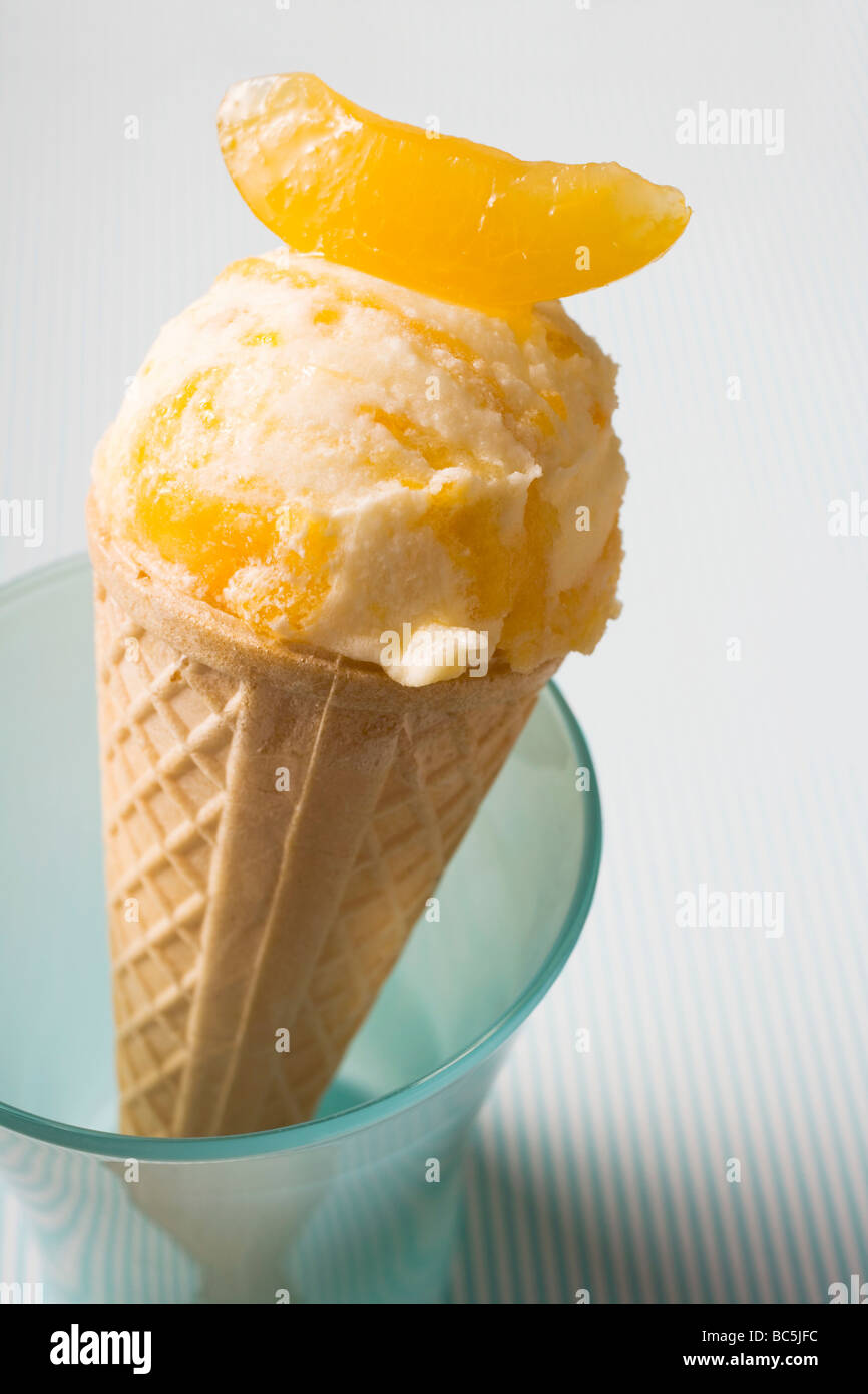 Orange ice cream in wafer cone in a beaker Stock Photo - Alamy