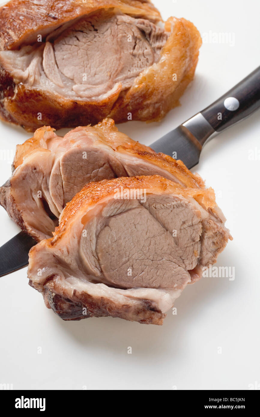 Roast shoulder of lamb being sliced Stock Photo - Alamy