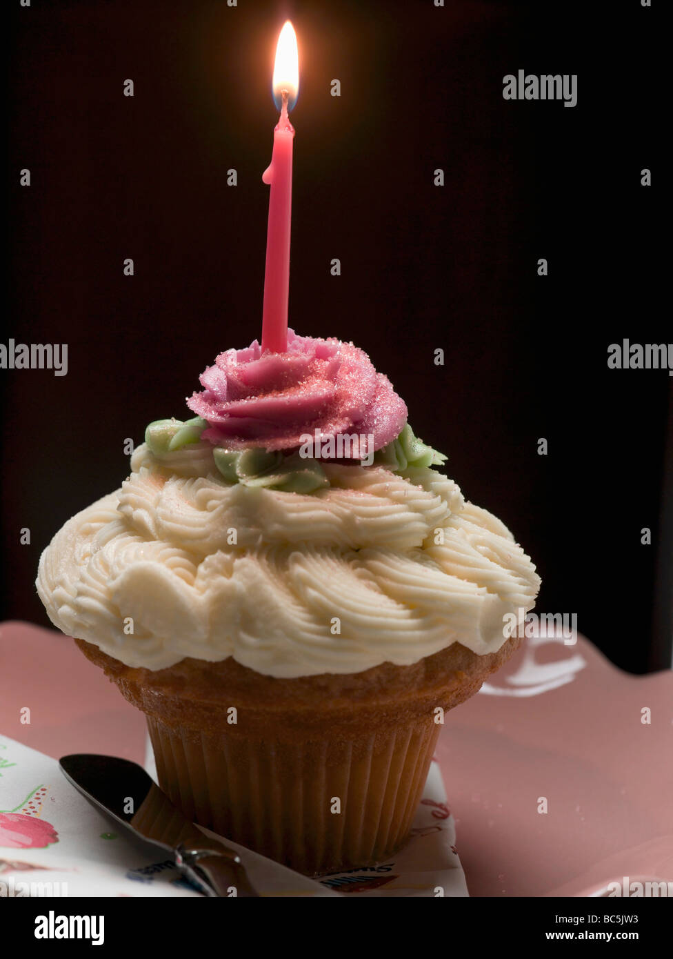 A cupcake with a burning birthday candle Stock Photo - Alamy