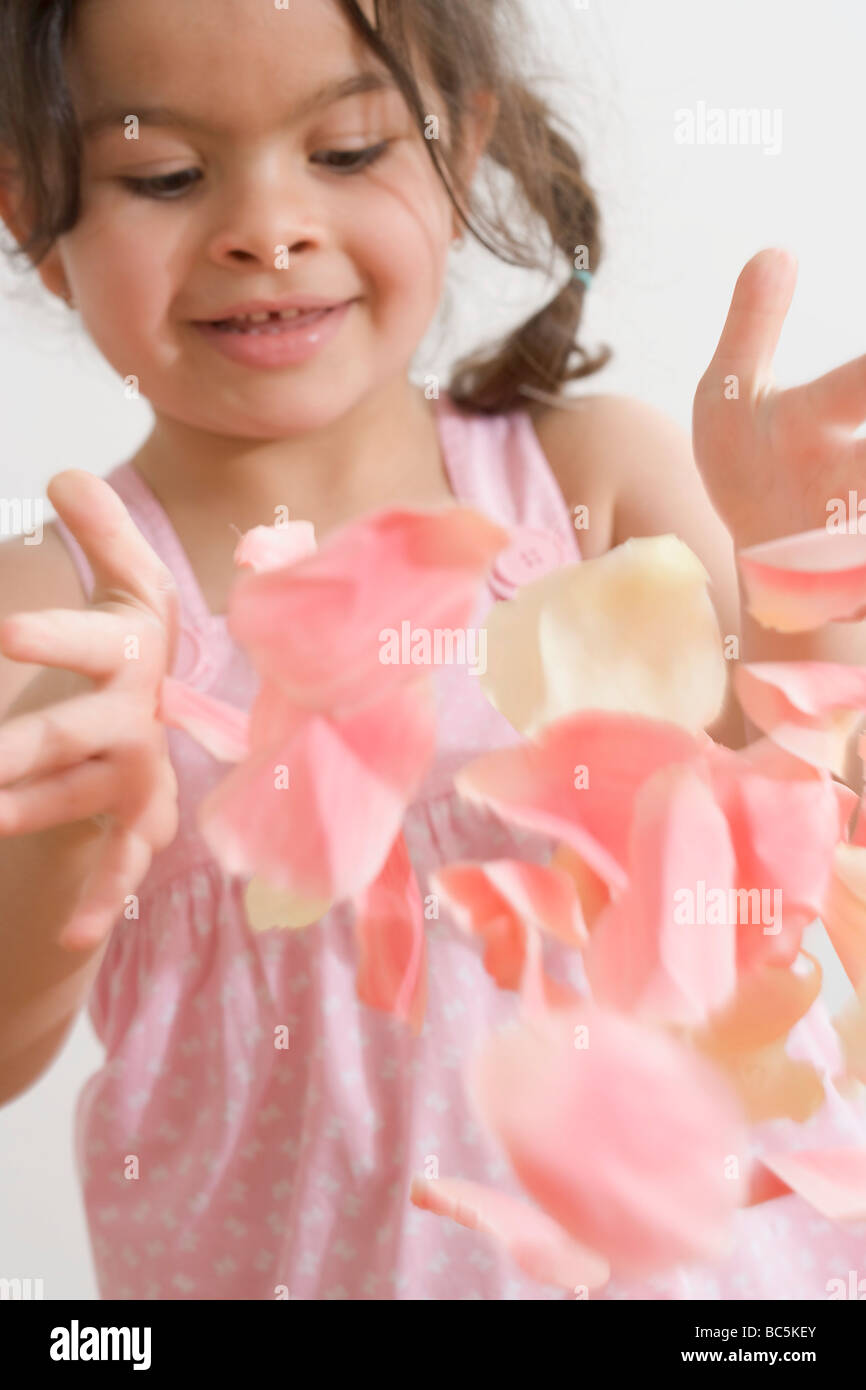 Pretty girl throwing rose petals Stock Photo - Alamy