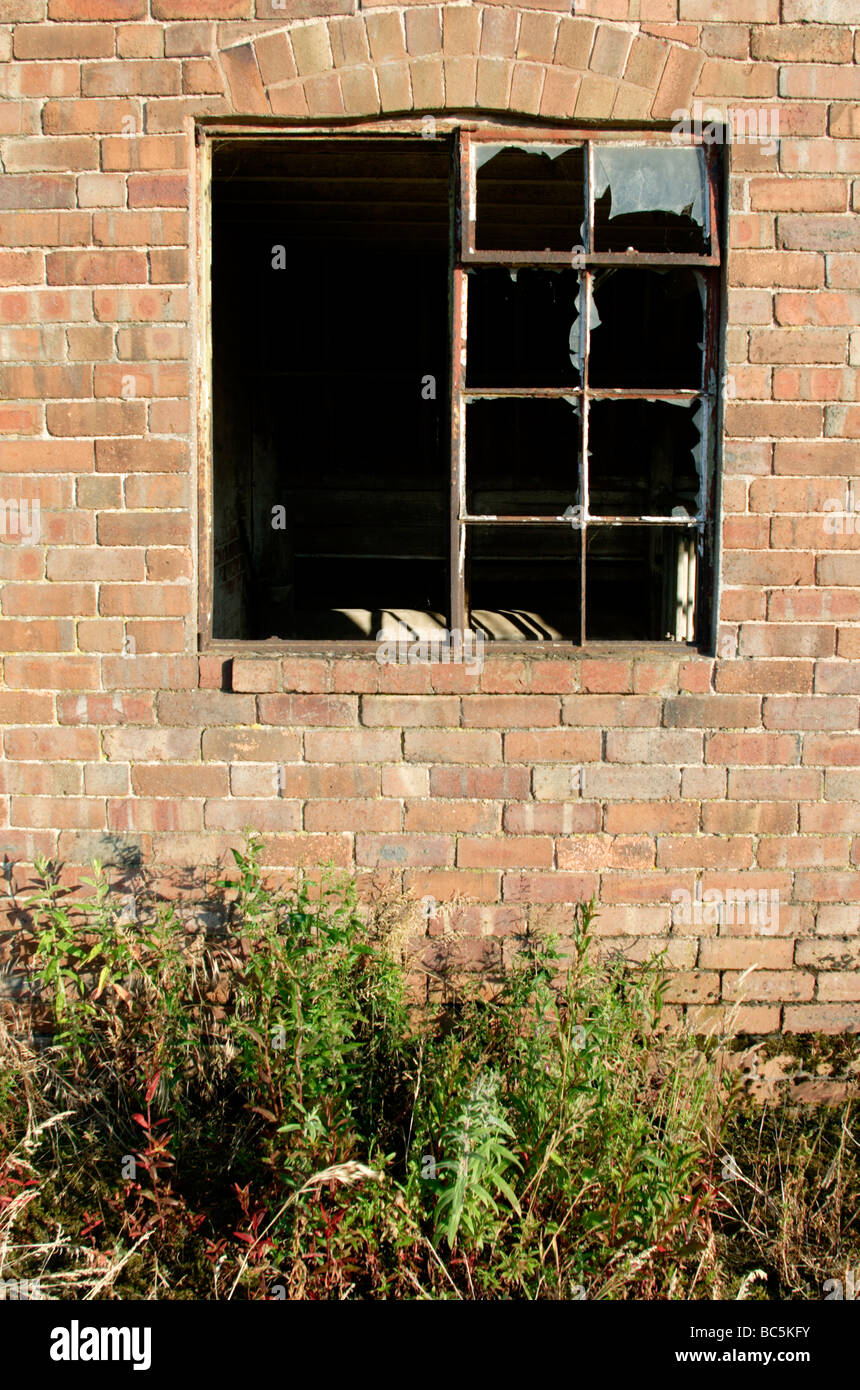 Broken window from old delelict farm building England UK Stock Photo ...