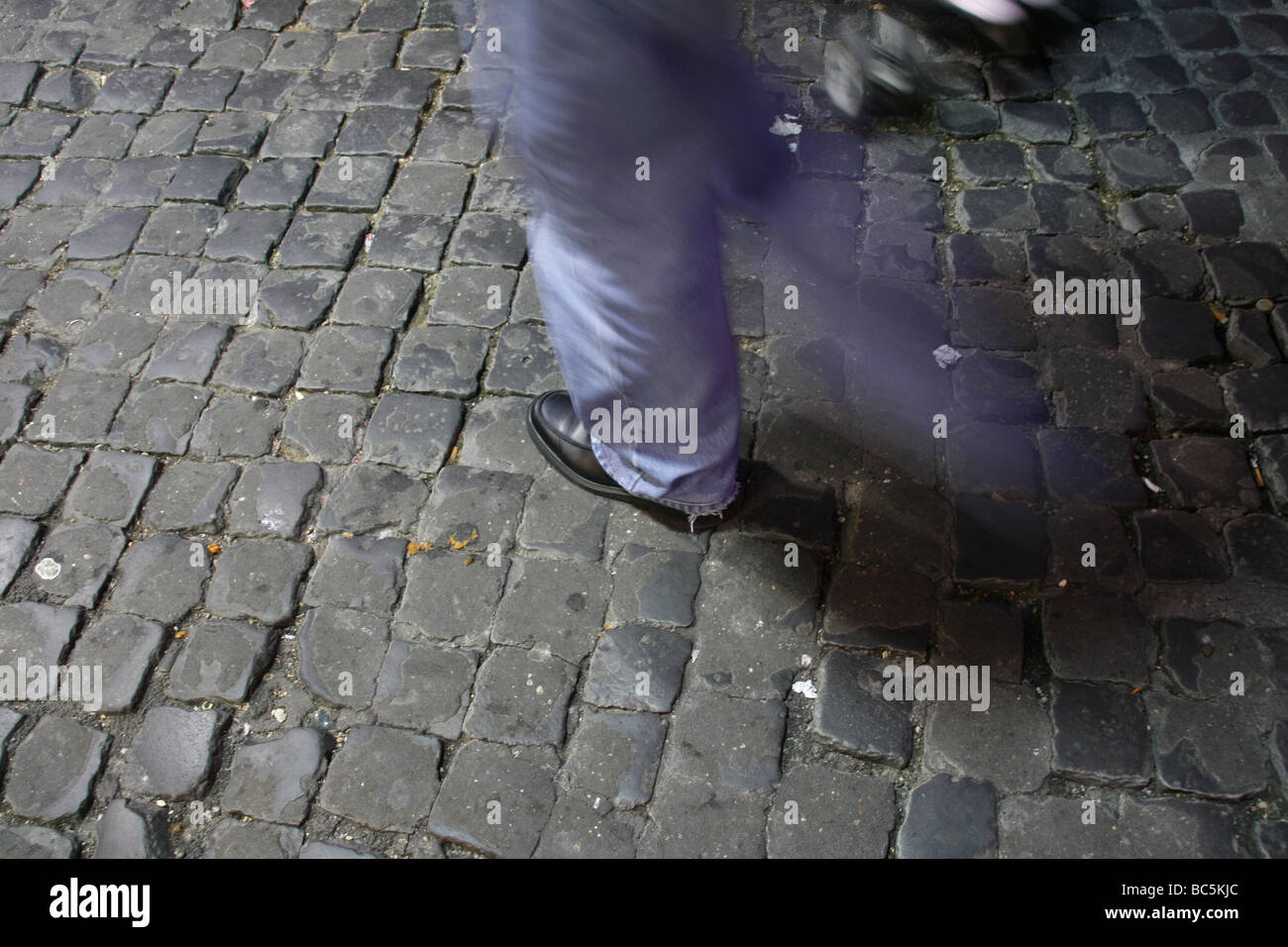 one person walking on city street pavement at night Stock Photo - Alamy