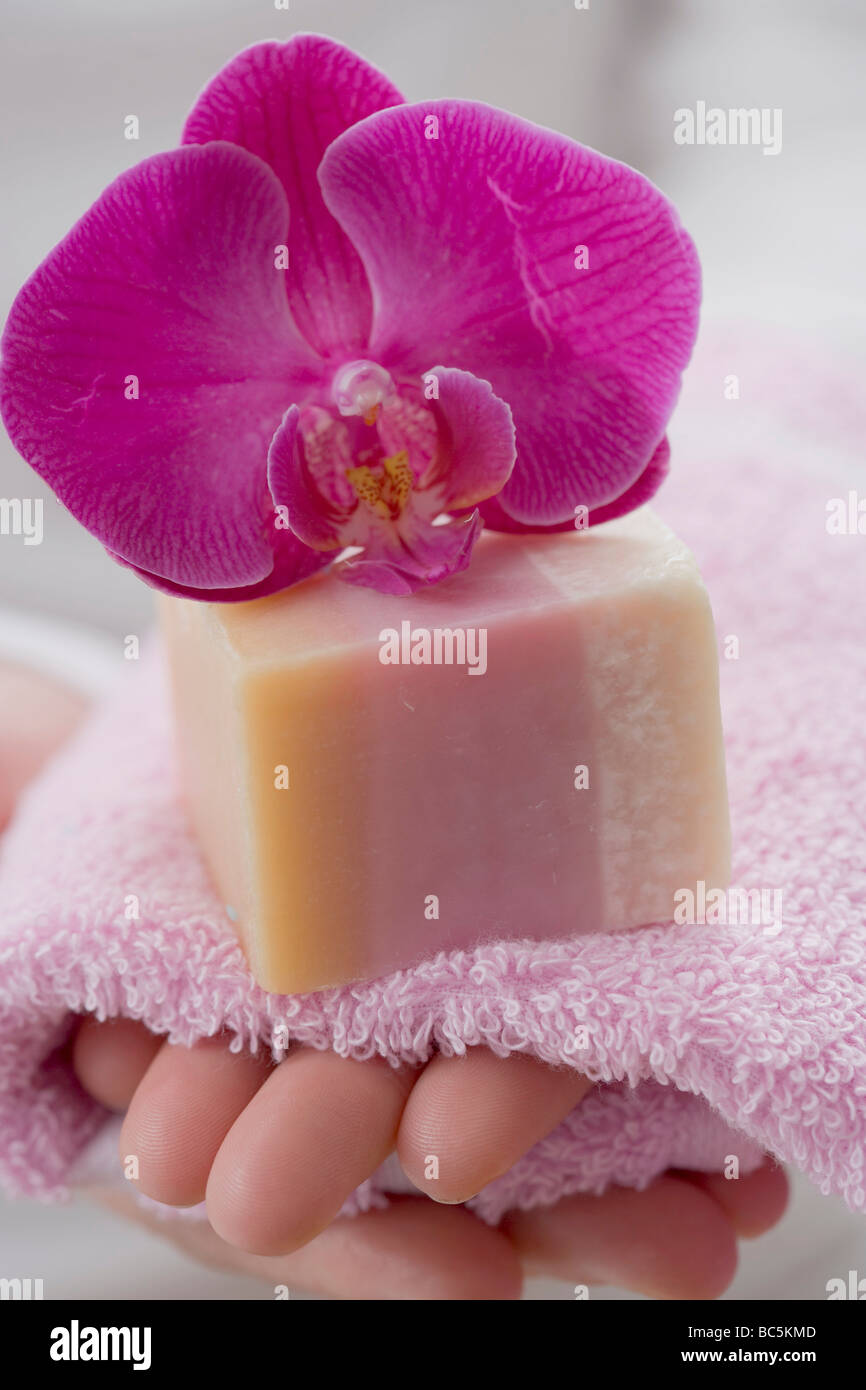 Young woman holding soap with orchid Stock Photo - Alamy