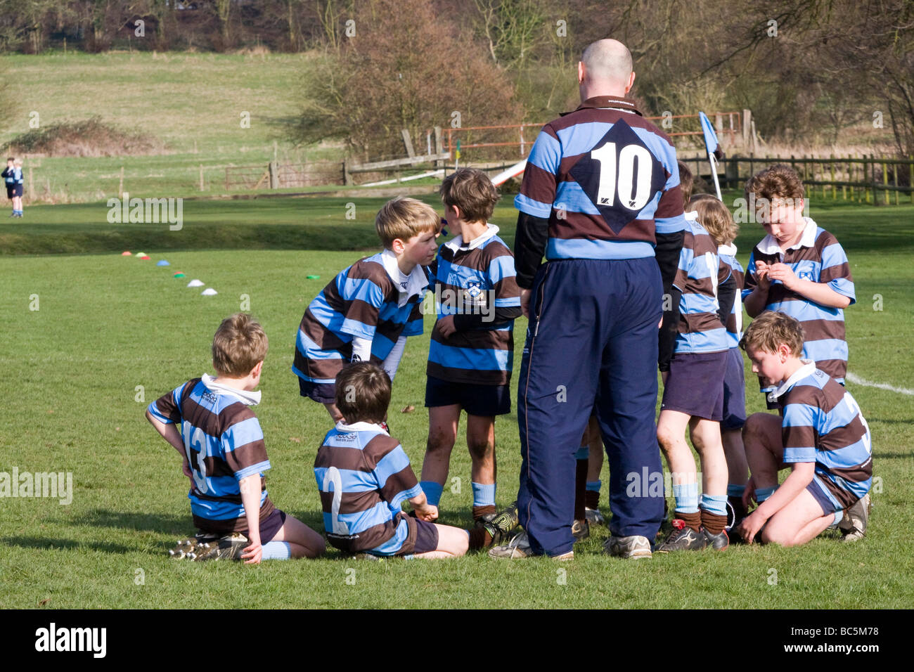Coach speaks to his very young team during a mini rugby tournament at a ...
