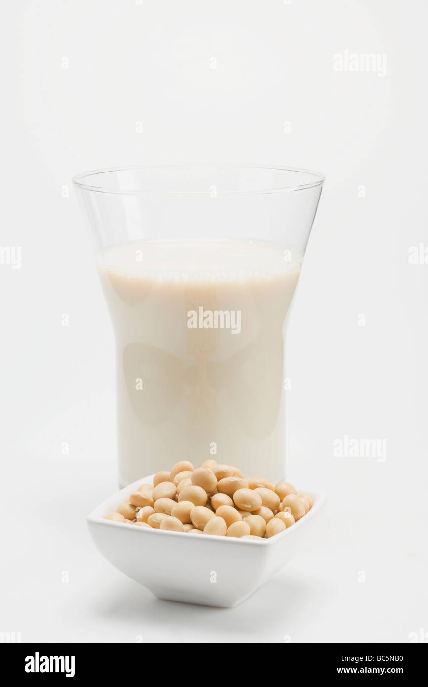 A glass of soya milk, small dish of soya beans in front Stock Photo - Alamy