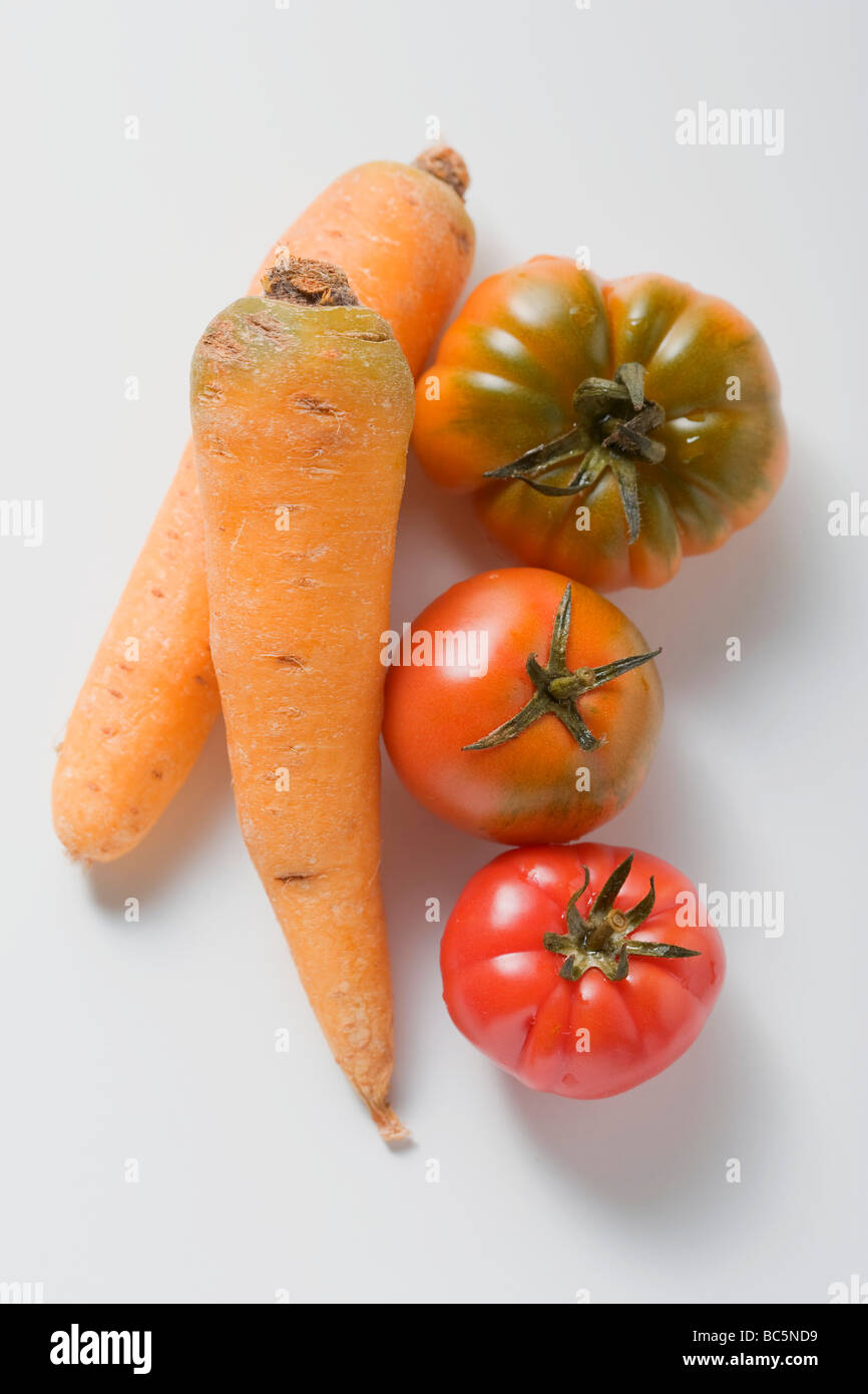 Two carrots and three tomatoes Stock Photo - Alamy