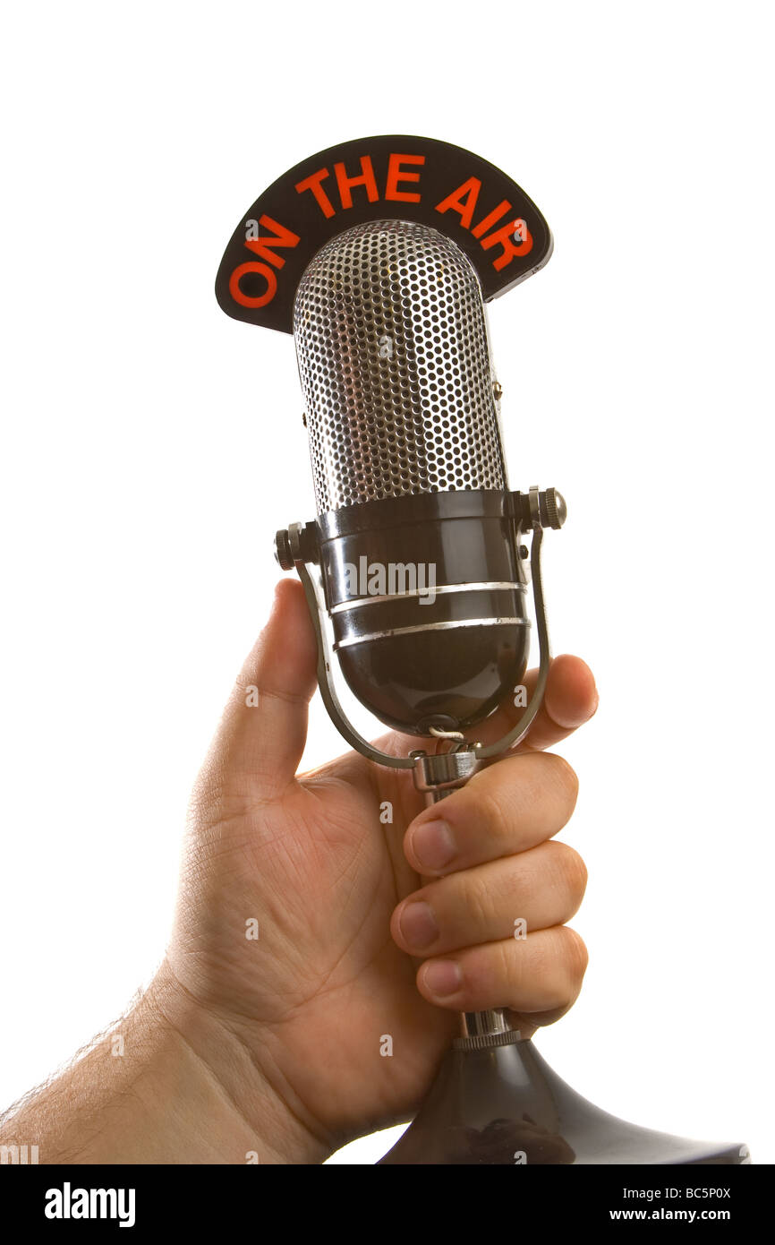 Retro Microphone held in hand over white background Stock Photo - Alamy
