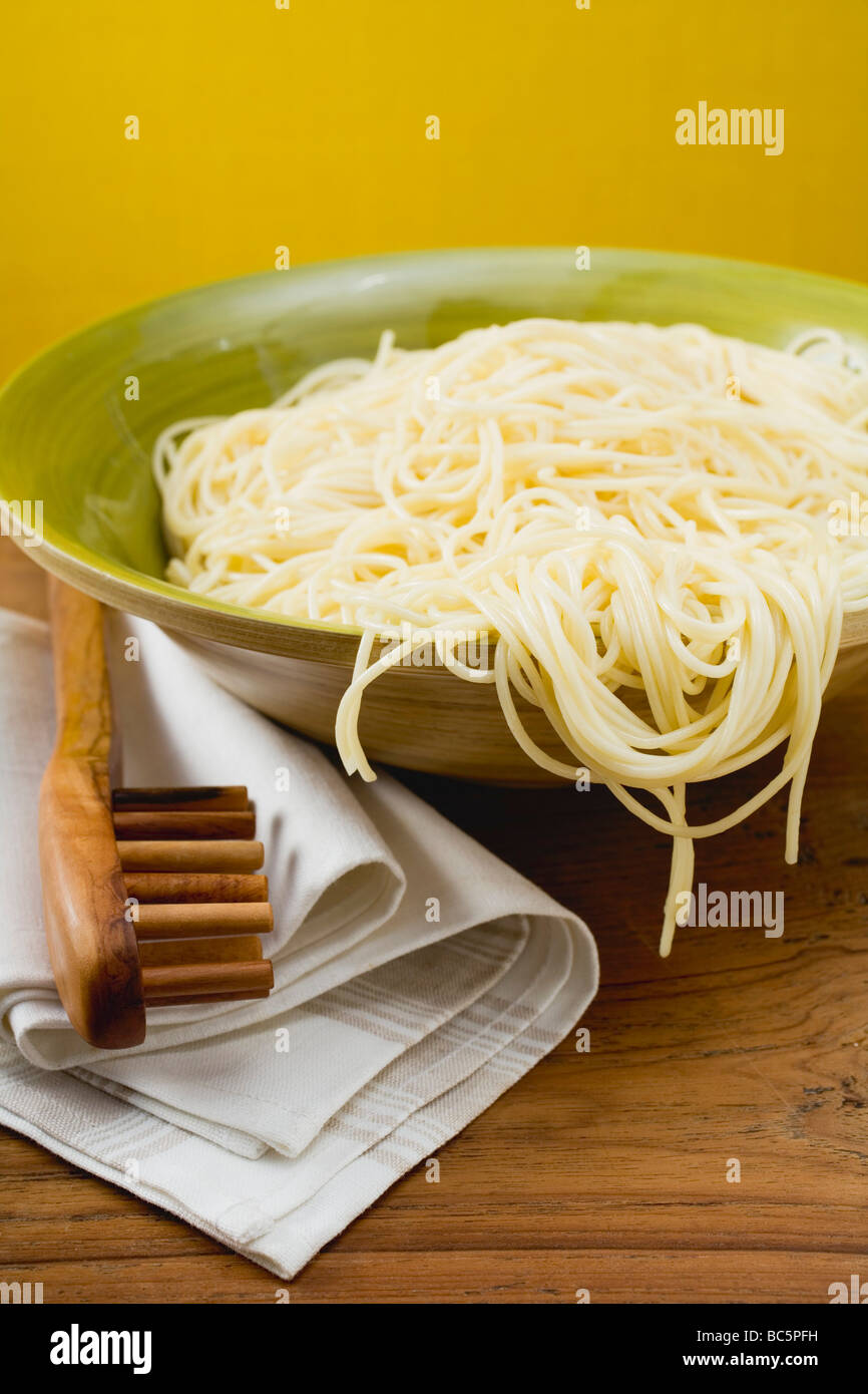A dish of cooked spaghetti with spaghetti server Stock Photo - Alamy