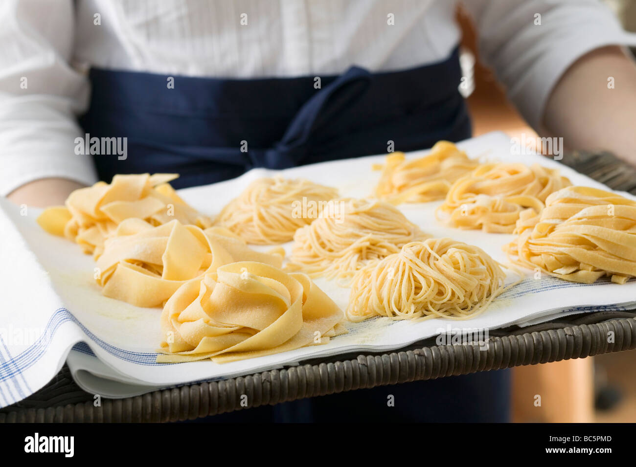 Three types of ribbon pasta on a tray Stock Photo - Alamy