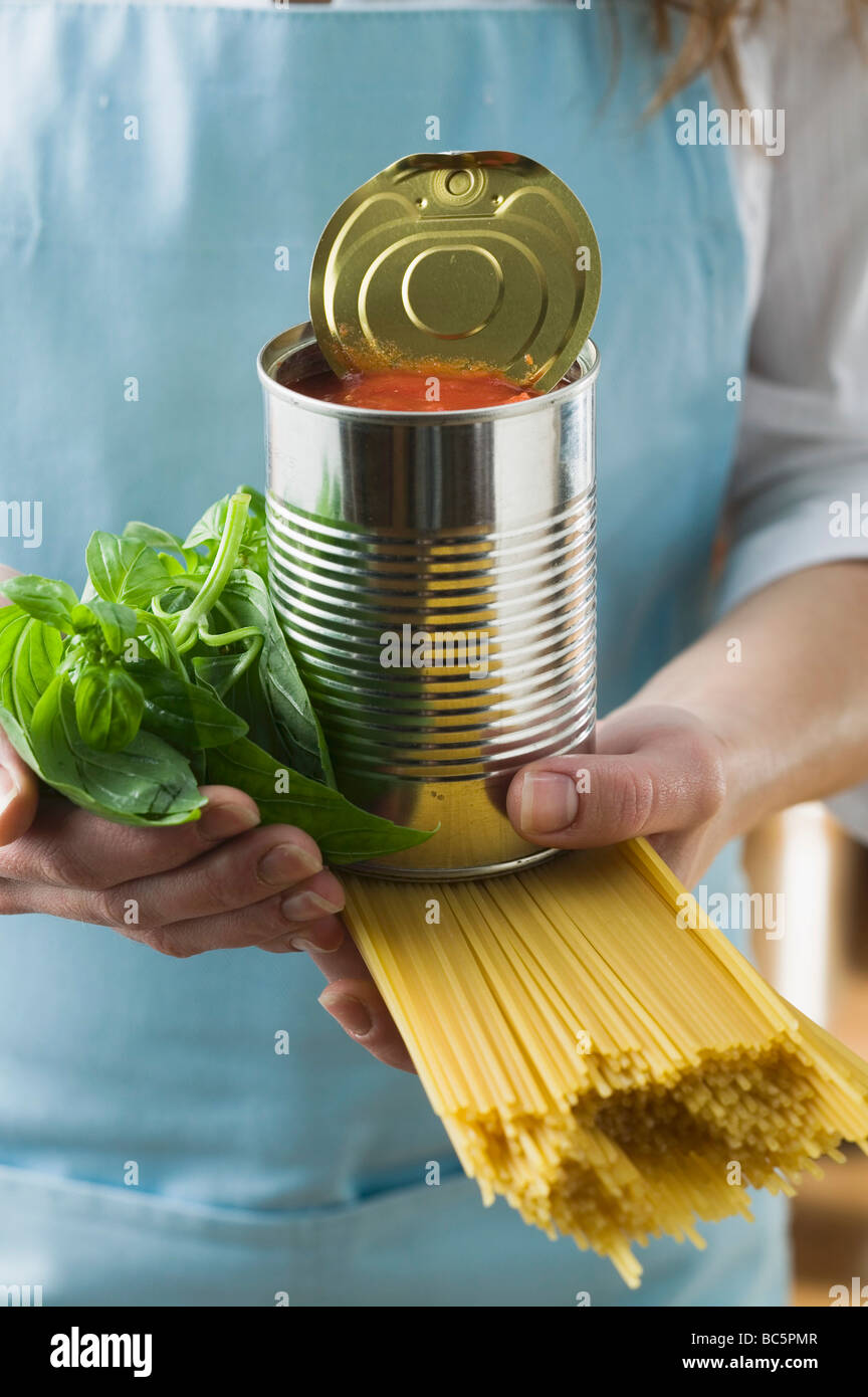 Tomato puree, basil and spaghetti Stock Photo - Alamy