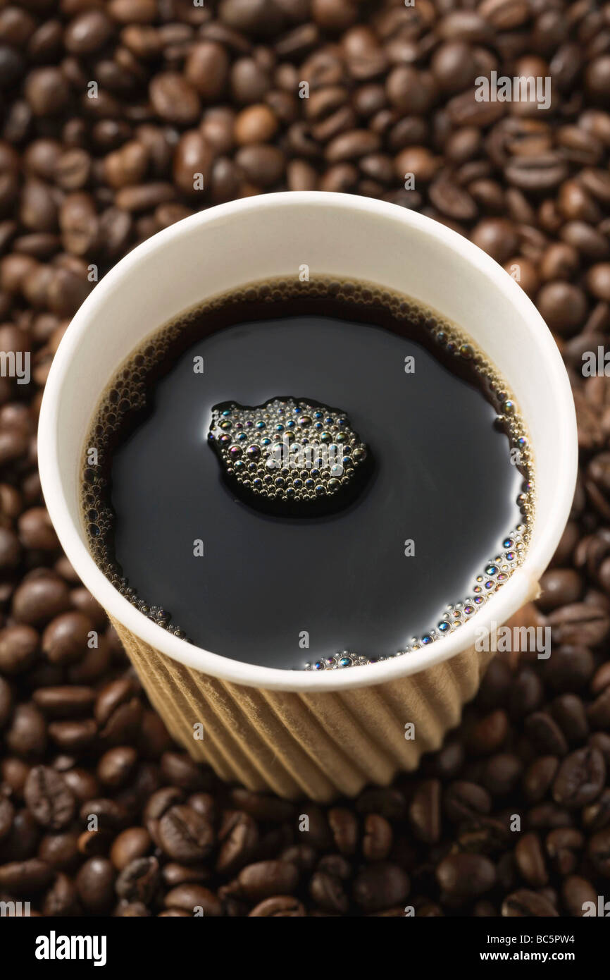 Coffee in paper cup standing on coffee beans Stock Photo - Alamy
