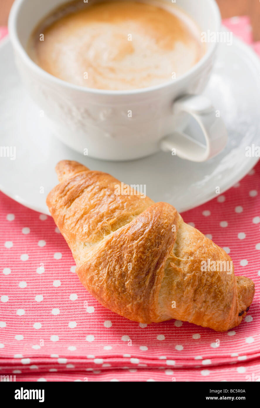 A croissant with a cup of cappuccino Stock Photo - Alamy
